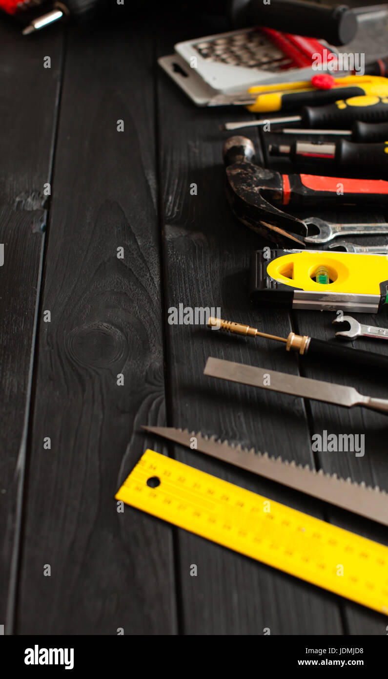 A set of tools laid out in a semicircle on top of the wooden table with ...