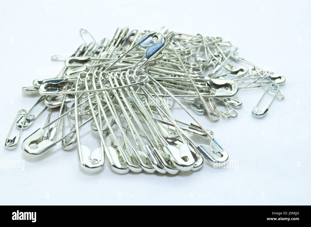 Stack of safety pins on white background Stock Photo - Alamy