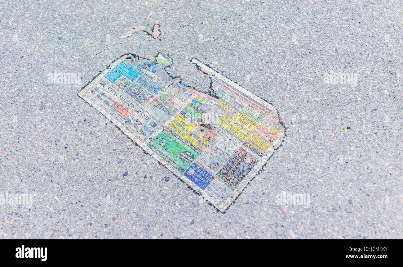 Montreal, Canada - May 26, 2017: Wet colorful newspaper on ground in ...
