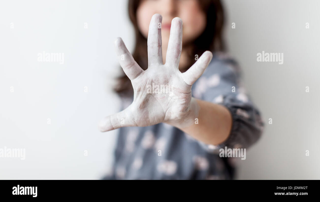 Silhouette young girl with her hand extended signaling to stop. Concept ...
