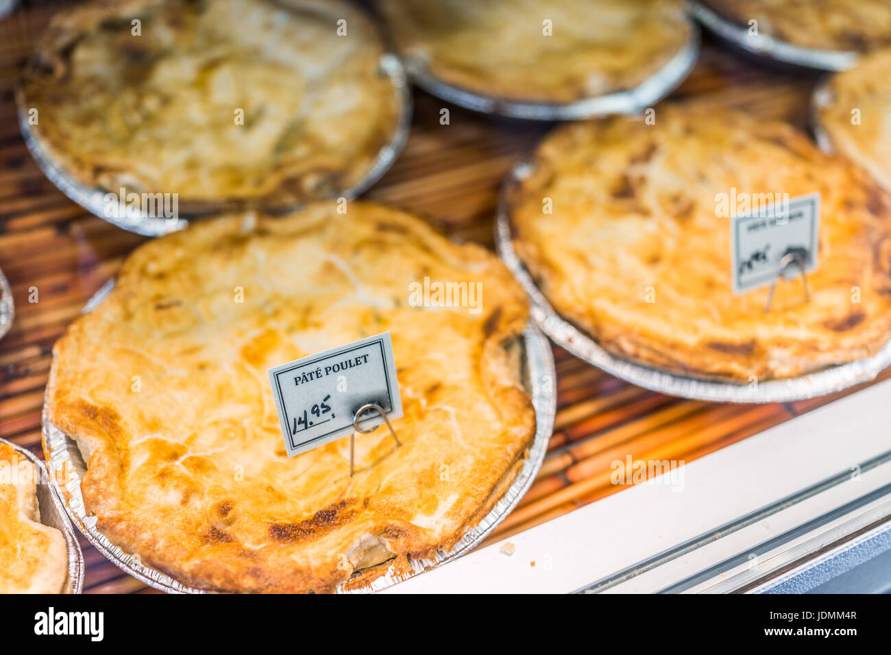 Chicken pate meat pies on display with signs in French in bakery Stock ...