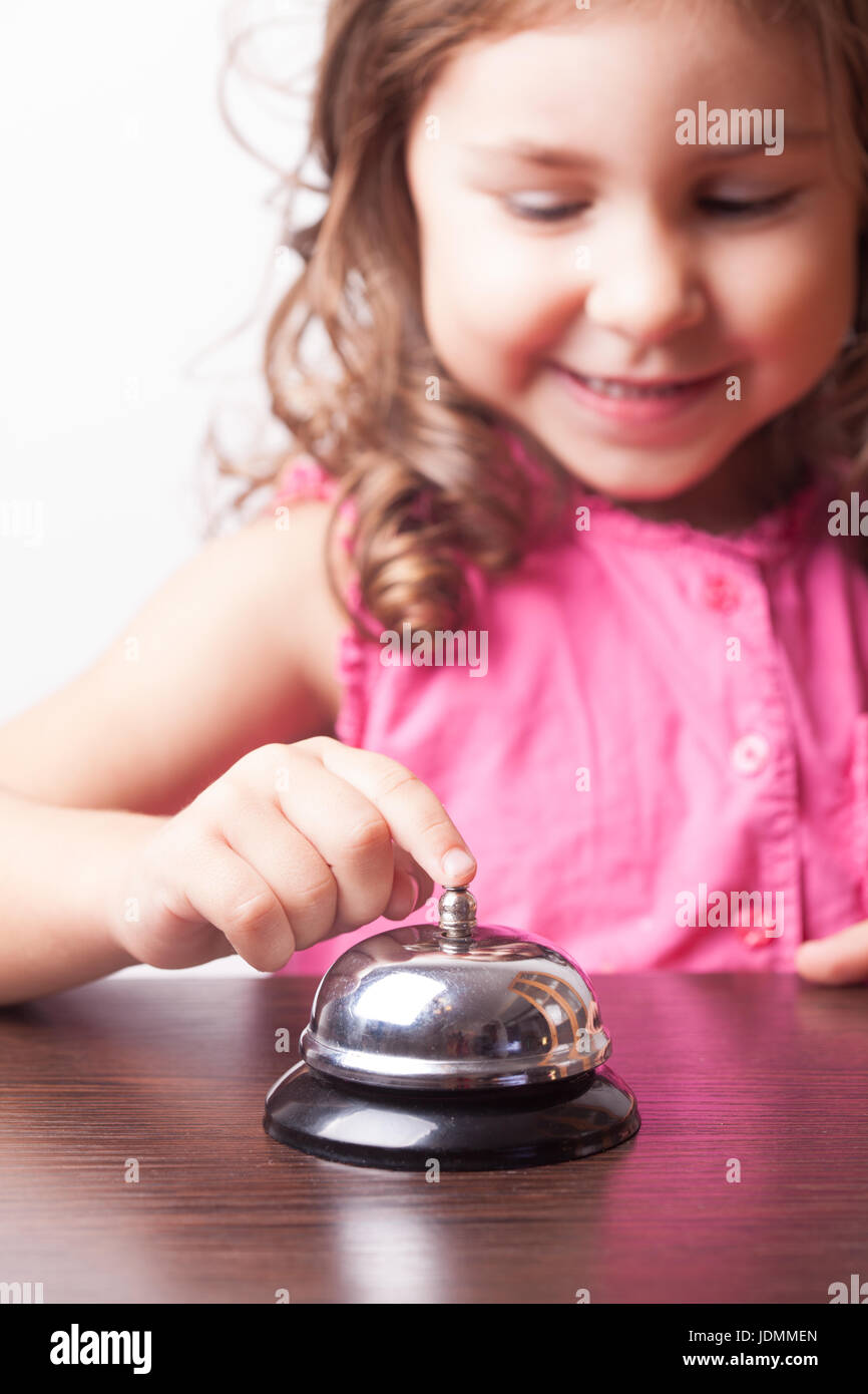 Little pretty girl push on the bell, board game on time Stock Photo - Alamy