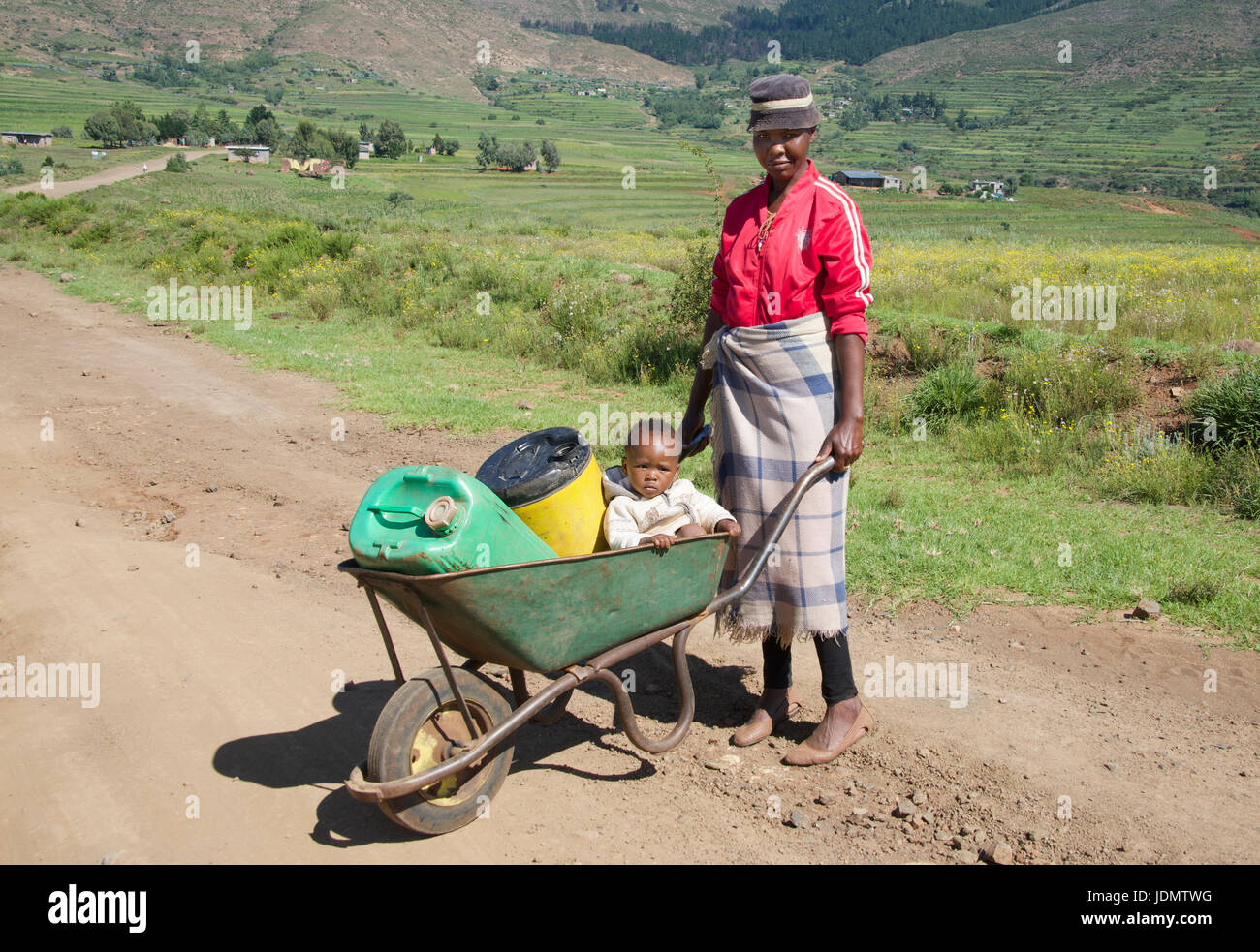 Mother transporting baby in wheelbarrow Malealea Mafeteng District ...