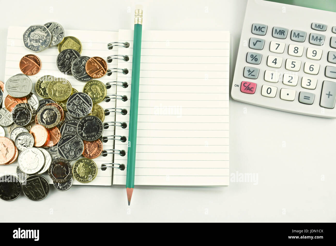 A note book with pencil and calculator, counting costs Stock Photo - Alamy