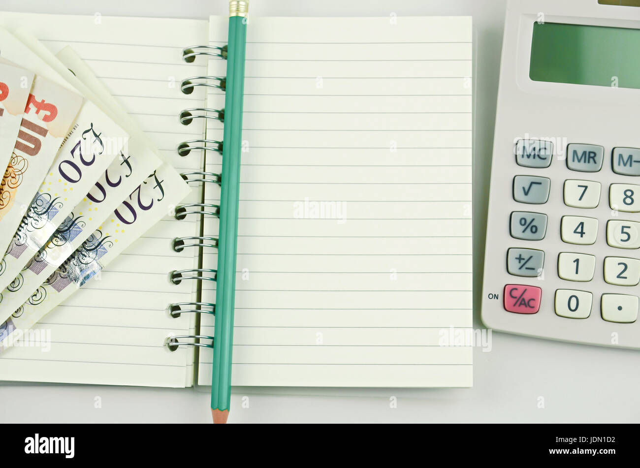 A note book with pencil and calculator, counting costs Stock Photo - Alamy