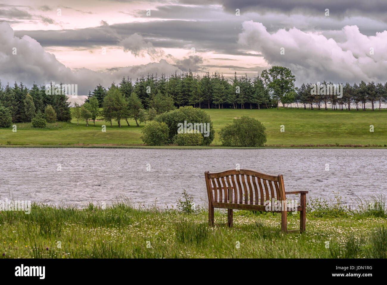 Piperdam lake in Scotland with the trees and hills in the distance ...