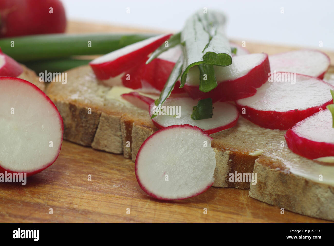 Fresh radish bread with spring leek as background Stock Photo - Alamy