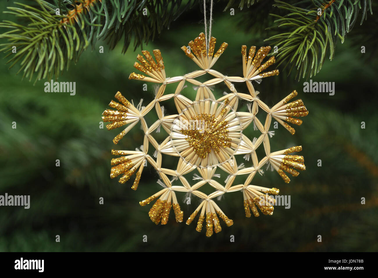 Decorative straw star on green background Stock Photo - Alamy