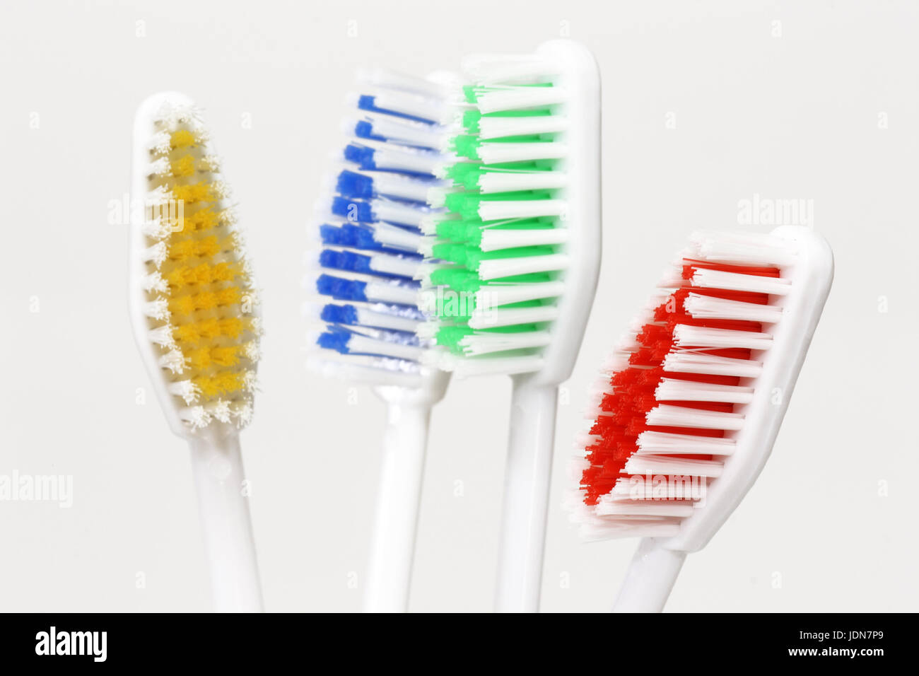 Close up of three different color tooth brush on white background Stock ...