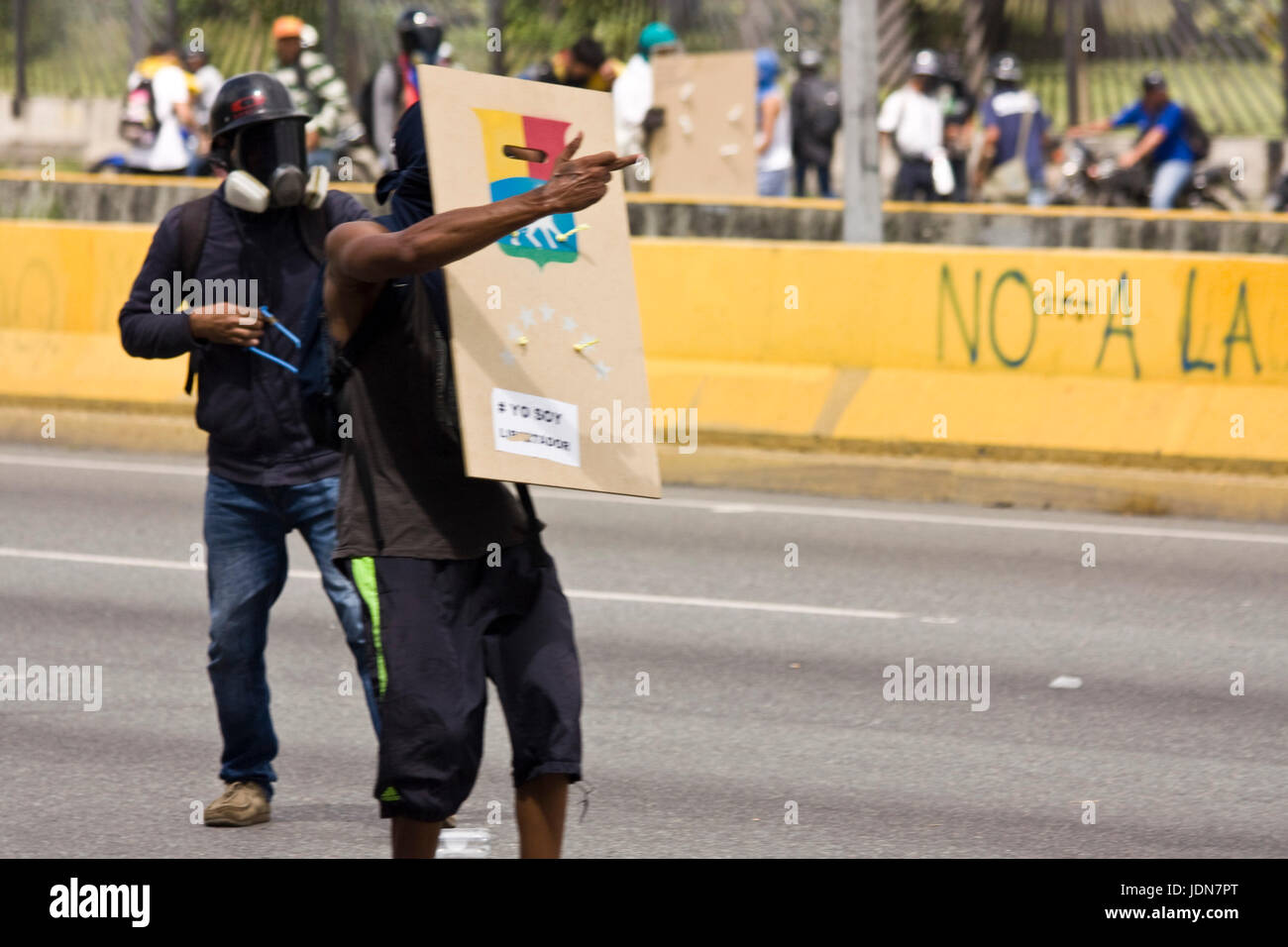 A demonstrator shows the finger during a protest on a highway in ...