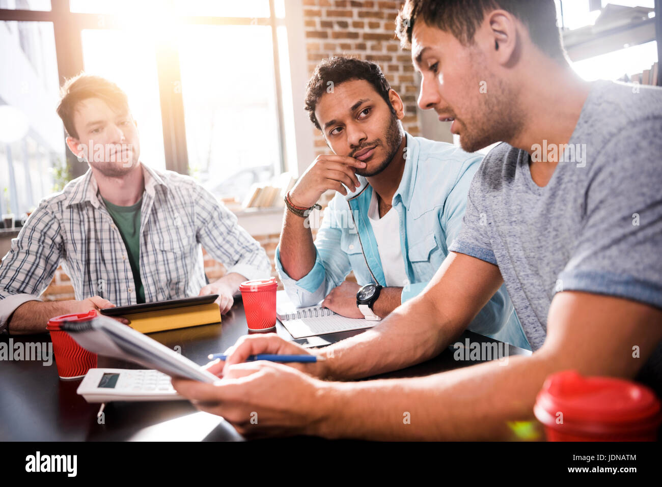Young professional working on project hi-res stock photography and ...