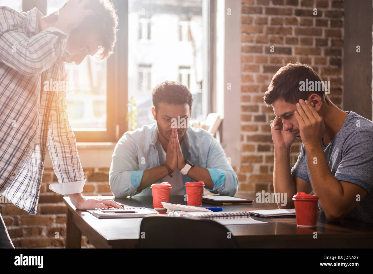 Young professionals brainstorming and working on new business project ...