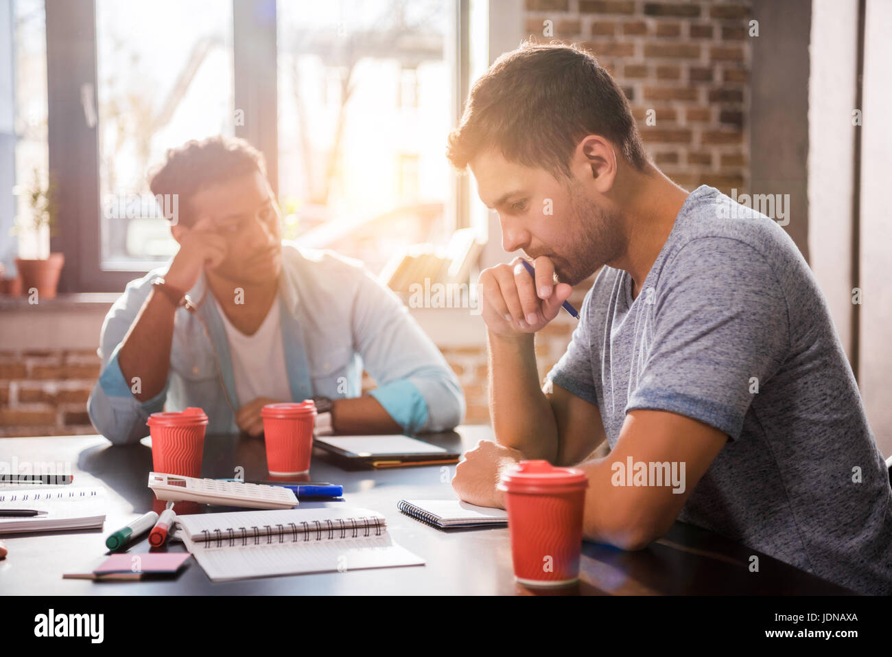 Young professionals brainstorming and working on new business project ...