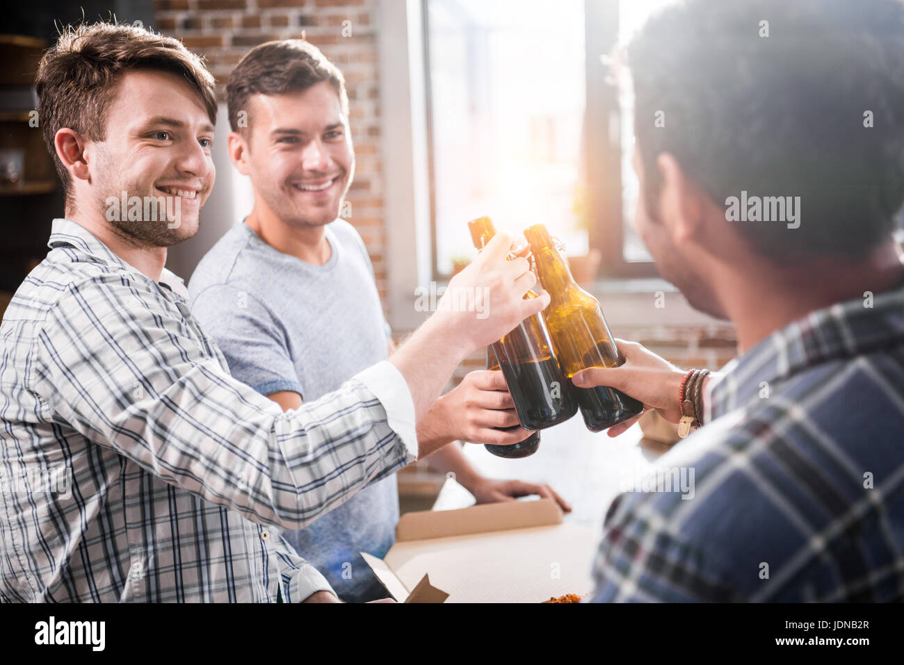 Men clinking bottles beer hi-res stock photography and images - Alamy