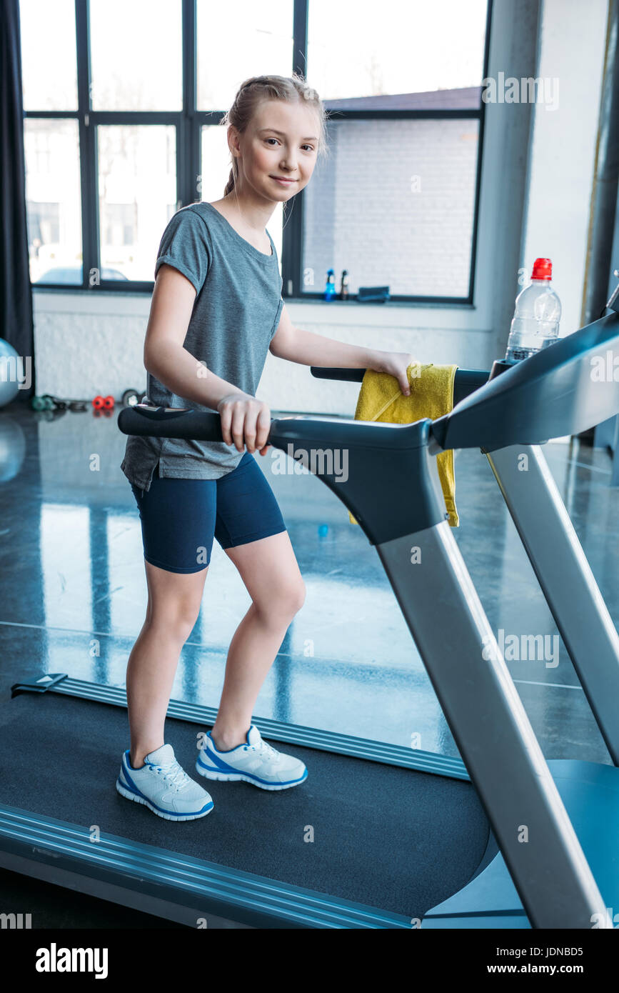preteen girl training on treadmill in fitness class. gym class kids ...