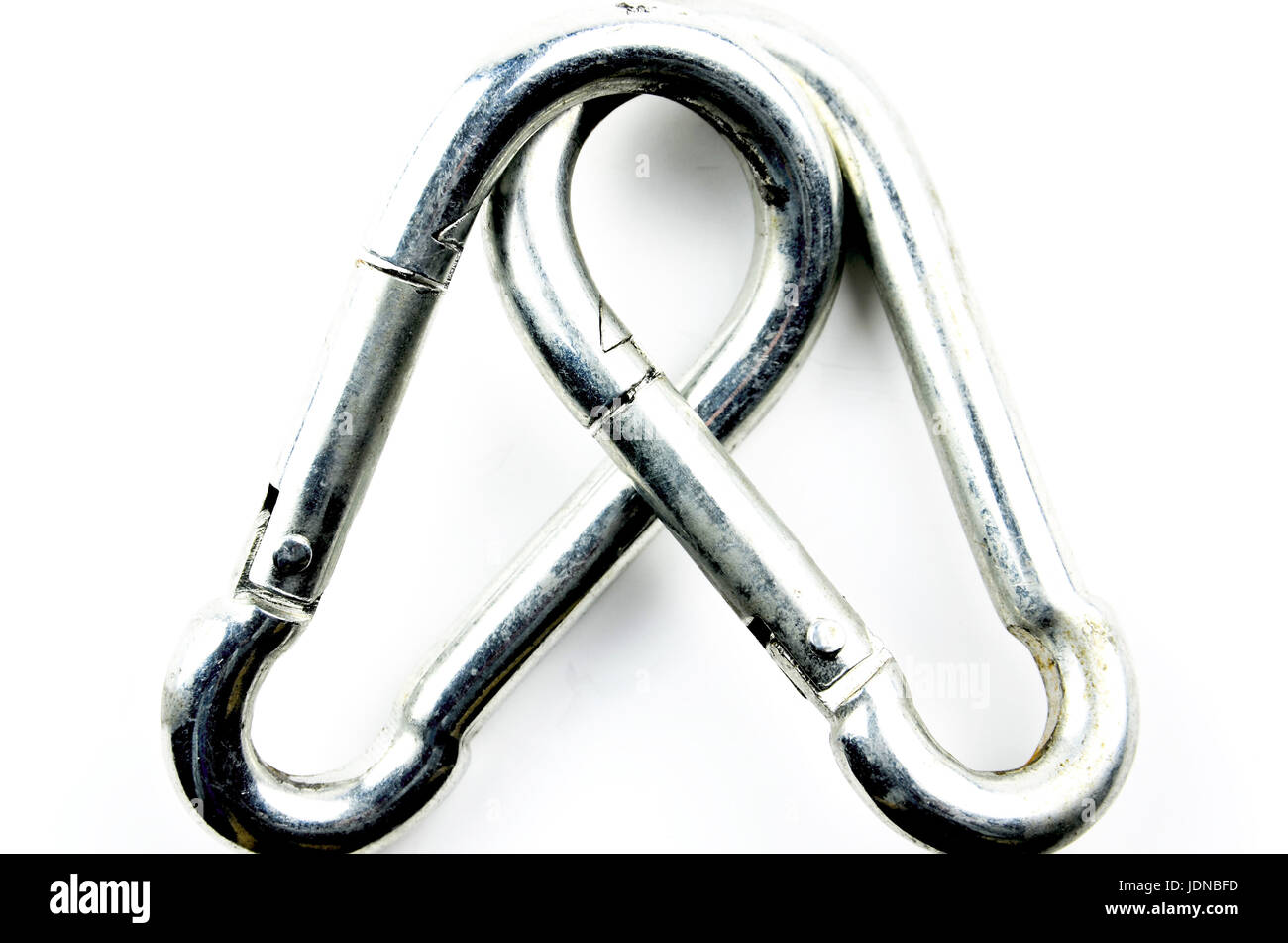 Two silver carabiner on white background Stock Photo - Alamy