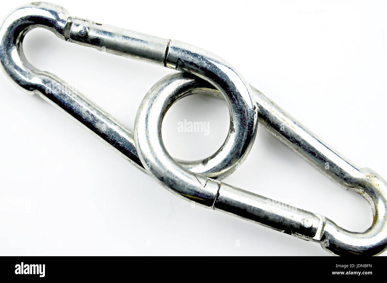 Two silver carabiner on white background Stock Photo - Alamy