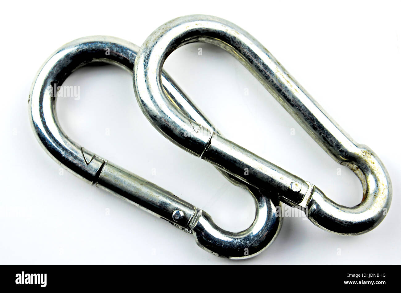 Two silver carabiner on white background Stock Photo - Alamy