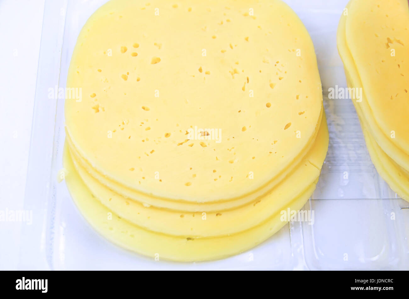 Stack of thin cheese pieces rounded Stock Photo - Alamy
