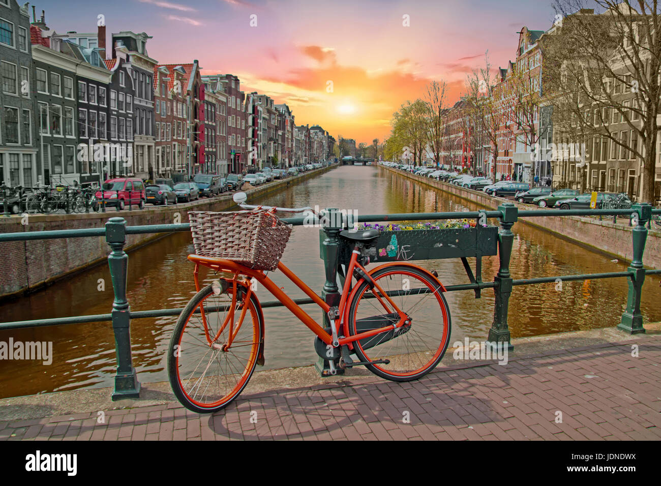 Orange bike in Amsterdam city center in the Netherlands at sunset Stock ...