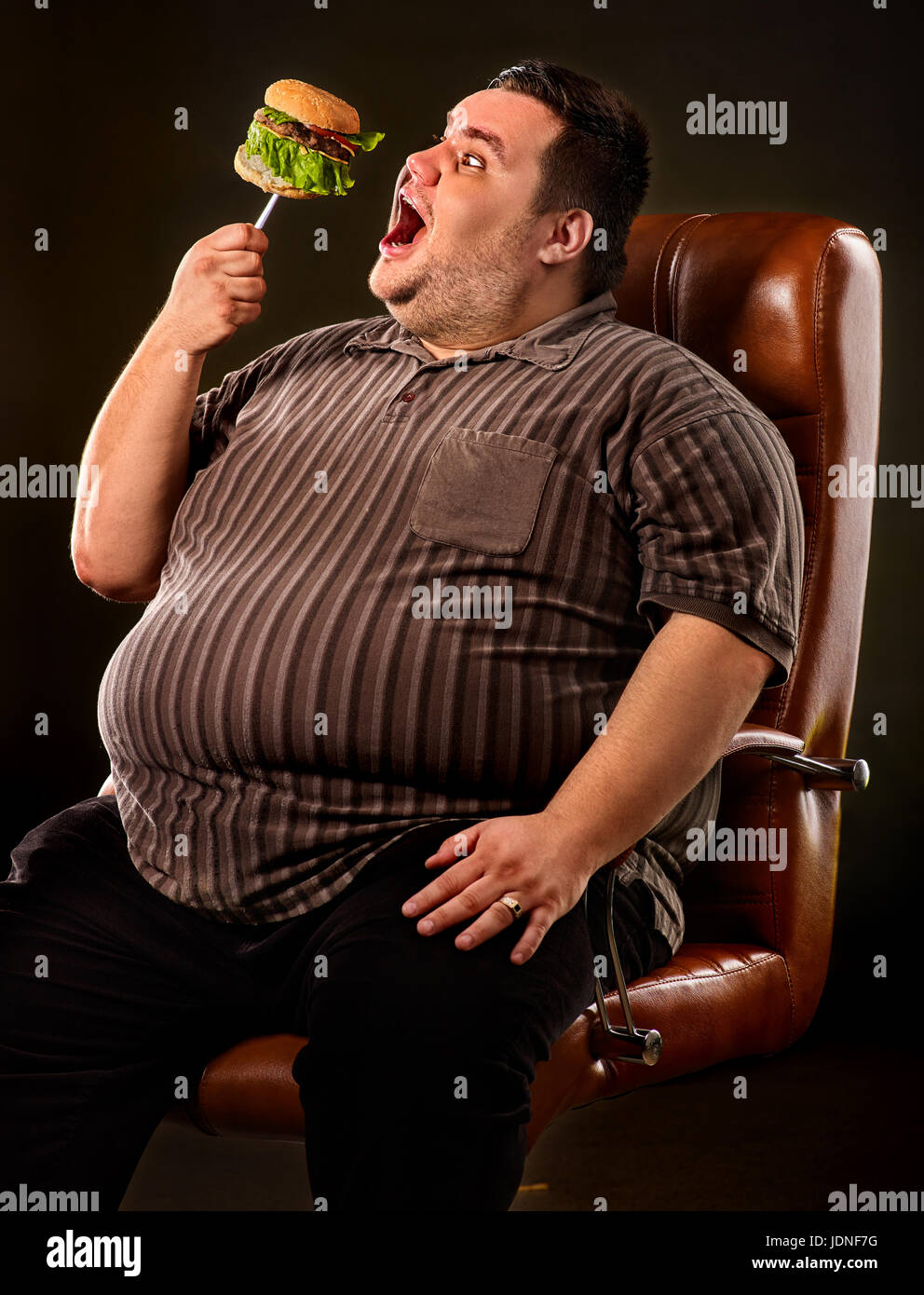 Fat man eating fast food hamberger. Breakfast for overweight person ...