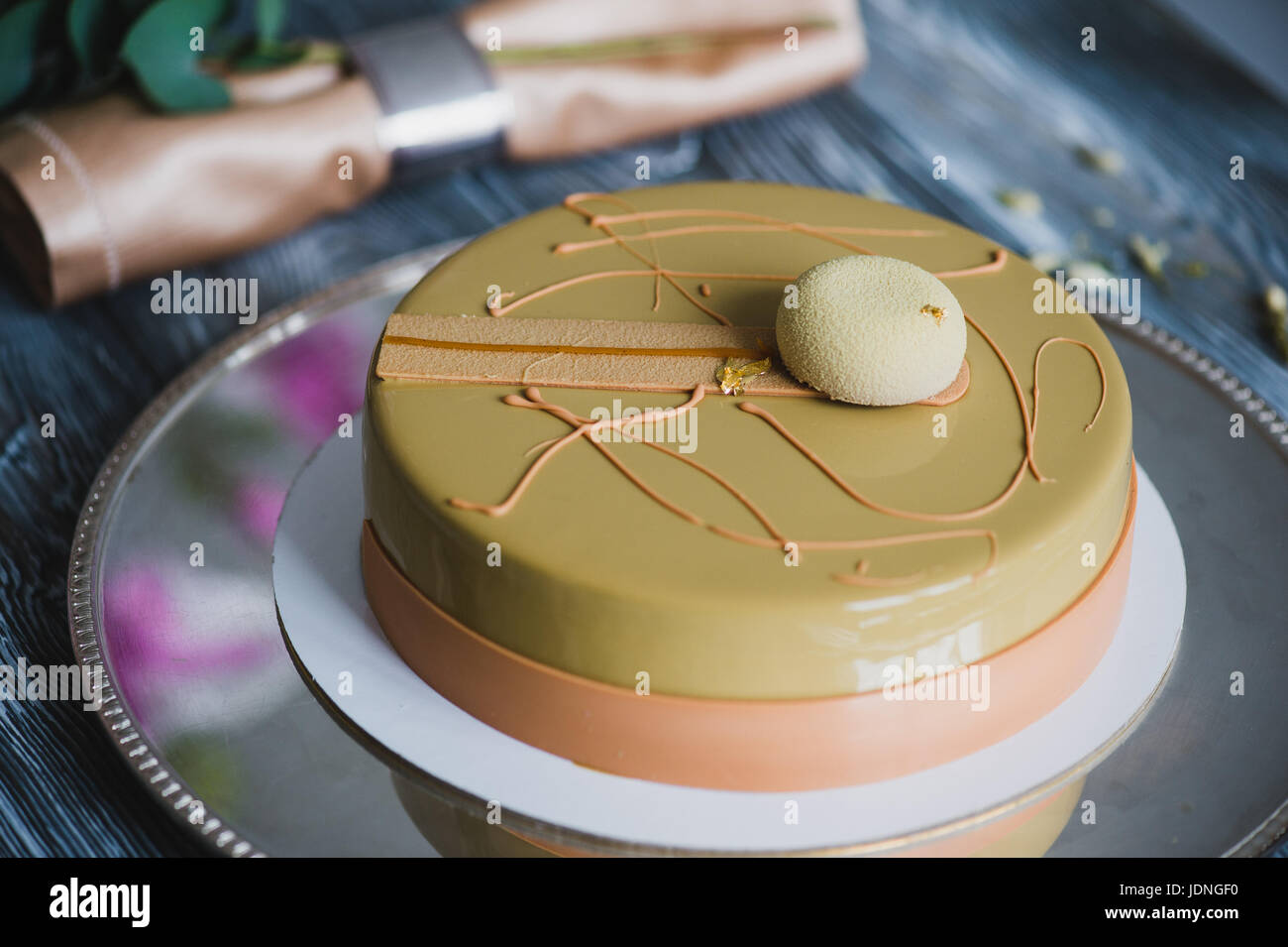 Bakery with piece of unusual yellow mousse cake with almond dacquoise ...