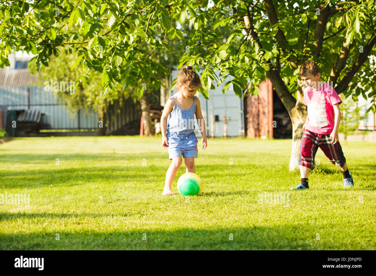 Children play with colorful ball in the rural backyard Stock Photo - Alamy