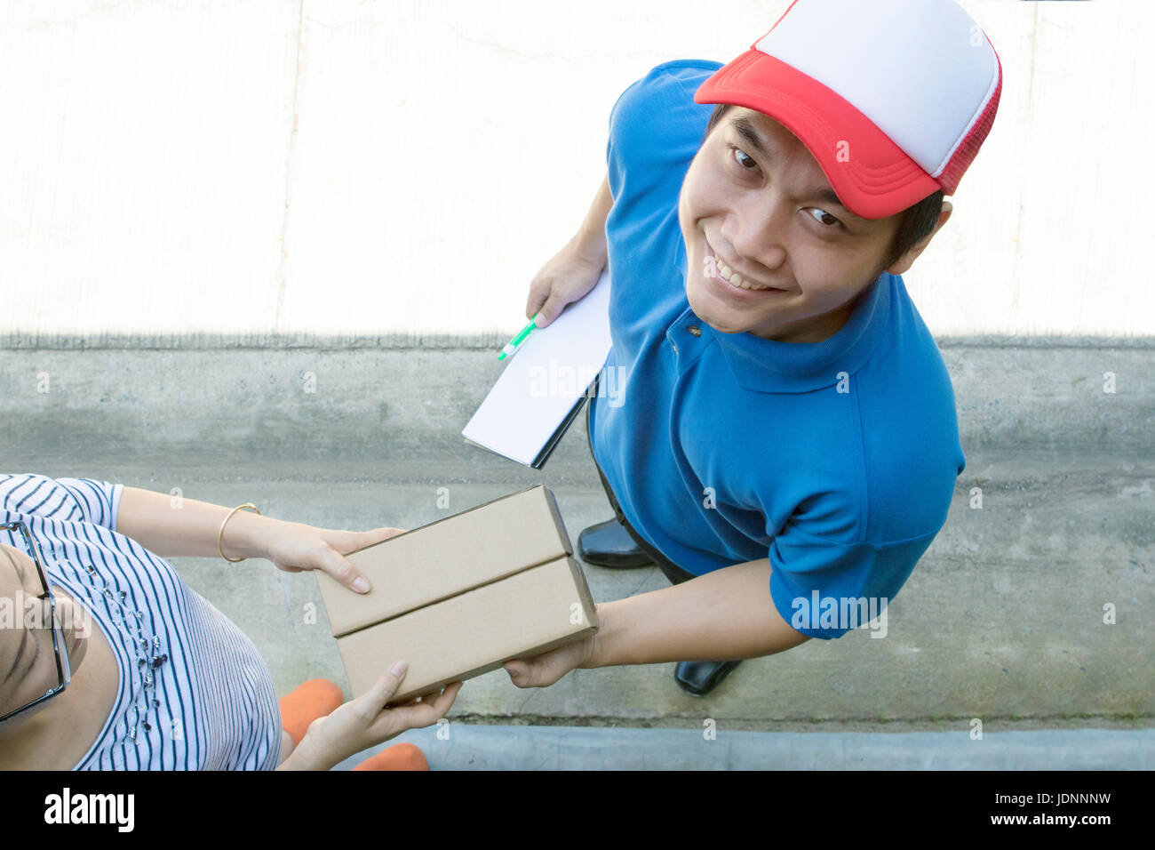 delivery man toothy smiling face and woman accepting delivering goods ...