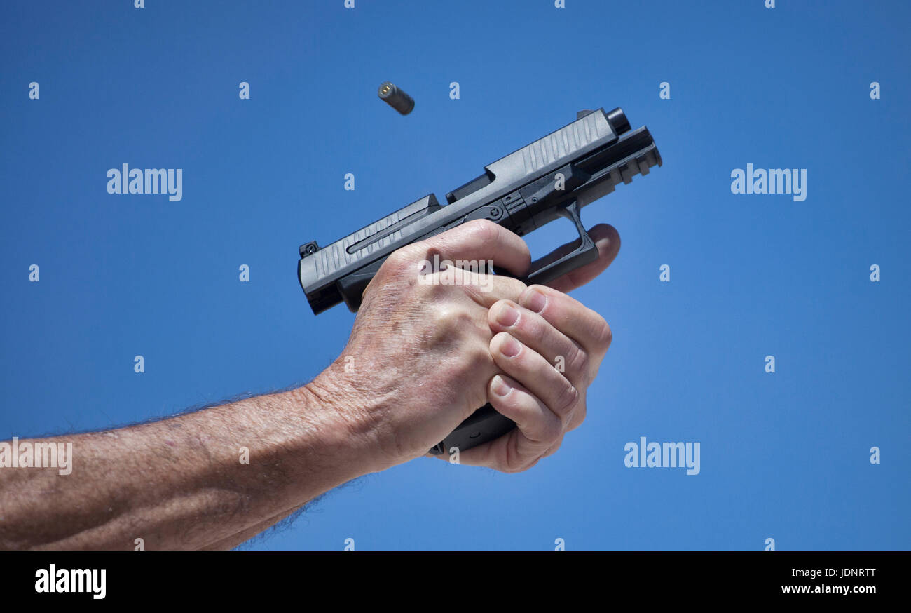 Empty casing flying out of a semi automatic pistol Stock Photo - Alamy