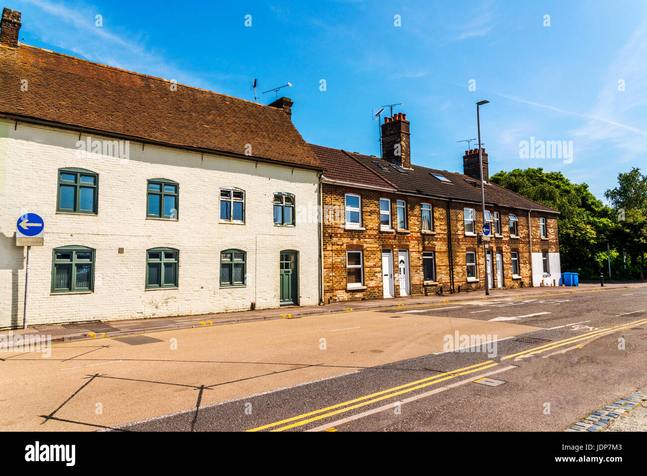 Typical old English buildings, low brick buildings across a narrow ...