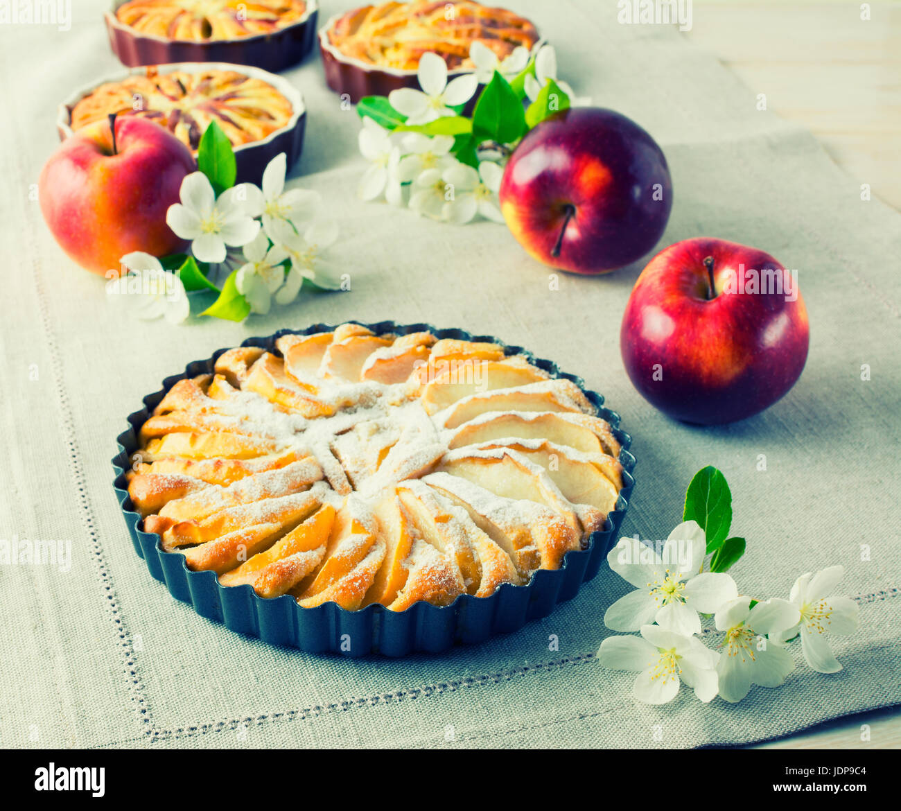 Sweet apple pie with spring flowers and ripe fruits, toned Stock Photo ...