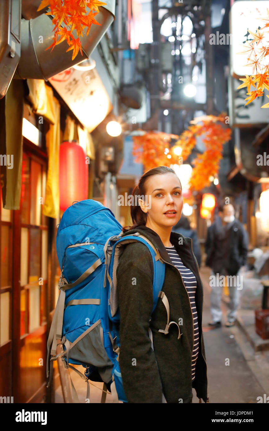 Caucasian backpacker downtown Tokyo at night, Tokyo, Japan Stock Photo ...