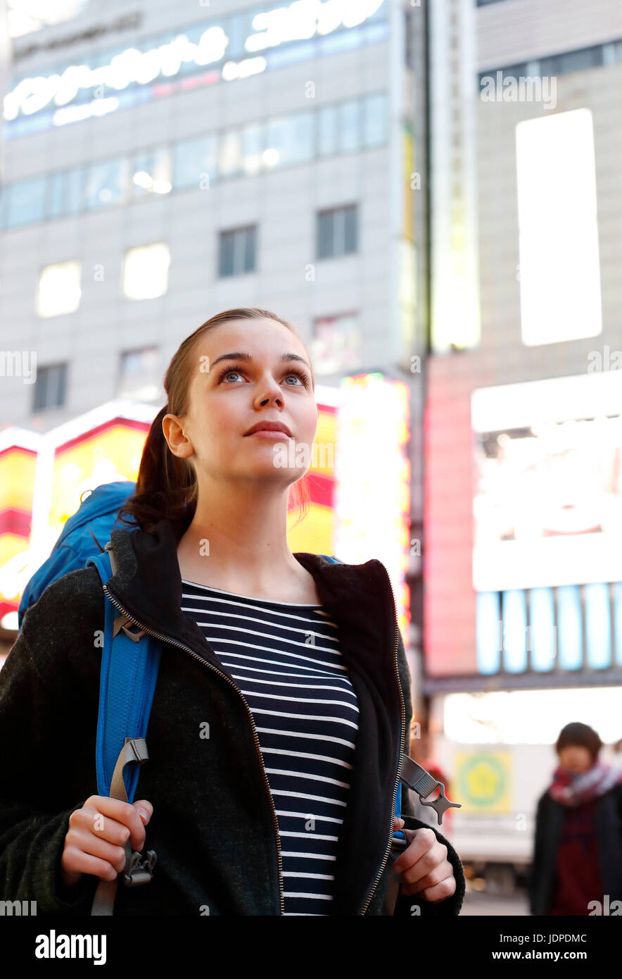 Caucasian backpacker downtown Tokyo at night, Tokyo, Japan Stock Photo ...