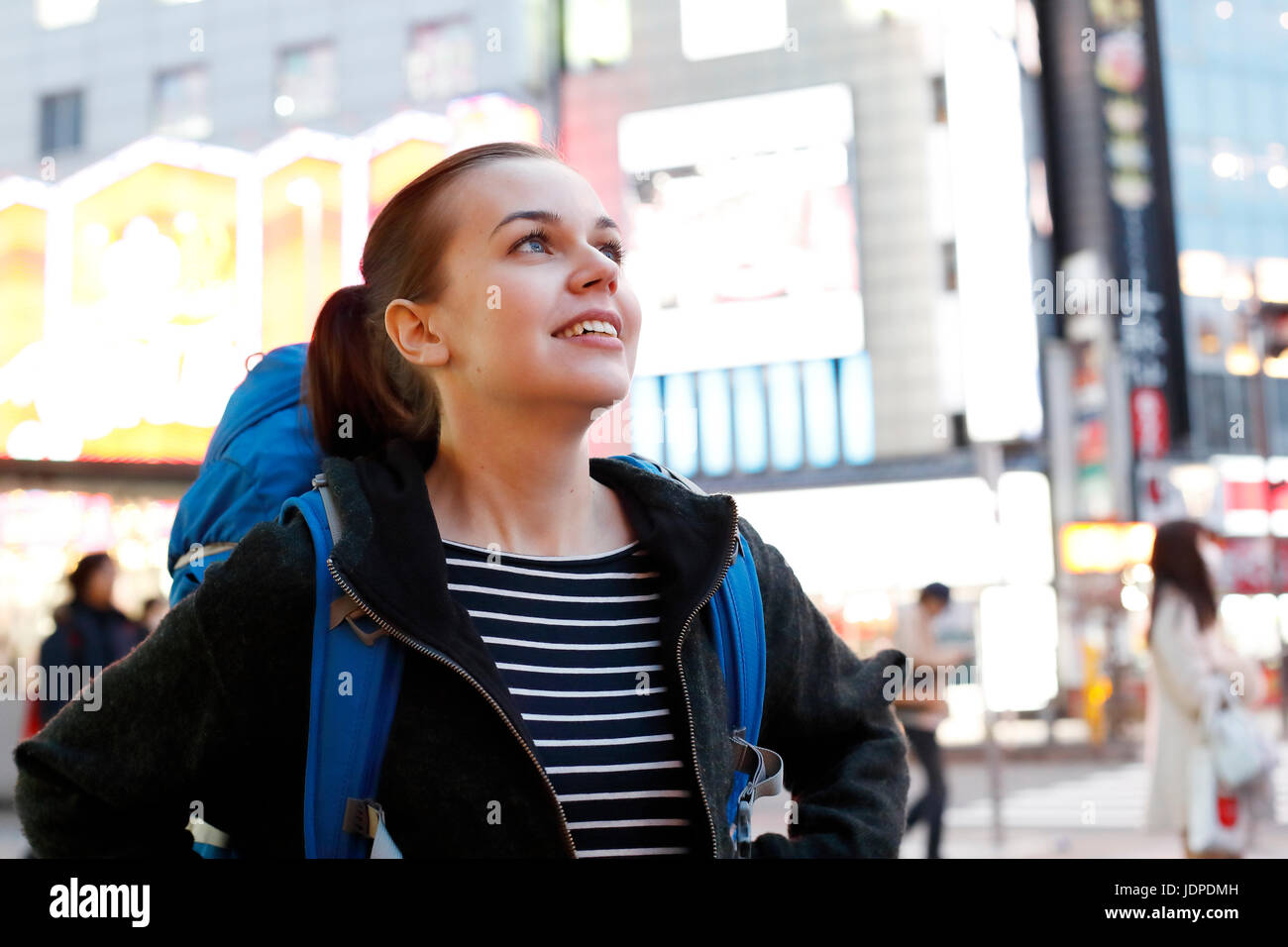 Caucasian backpacker downtown Tokyo at night, Tokyo, Japan Stock Photo ...