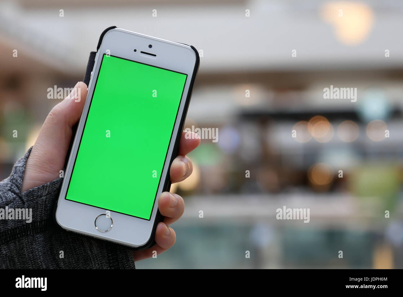 Burnaby, BC, Canada - May 05, 2017 : Woman holding green screen phone ...