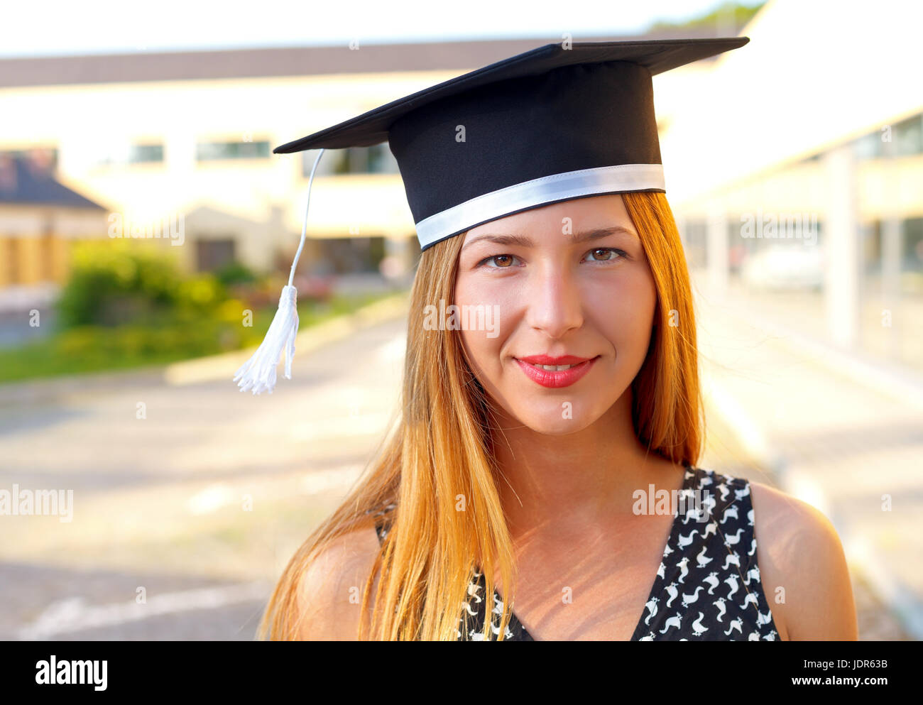 Gorgeous happy young woman wearing graduation hat Stock Photo - Alamy