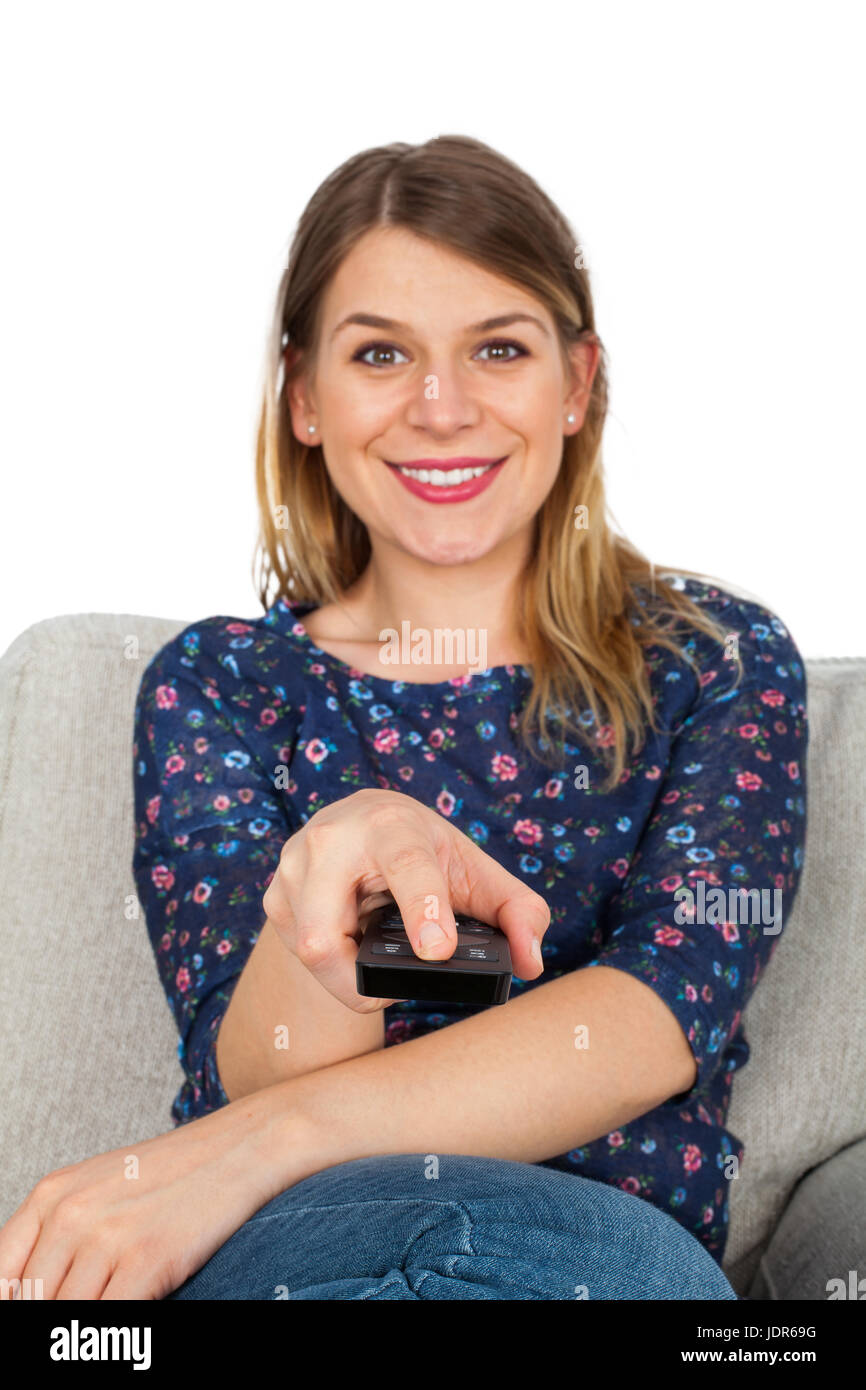 Picture of an attractive woman watching tv at home holding a remote ...