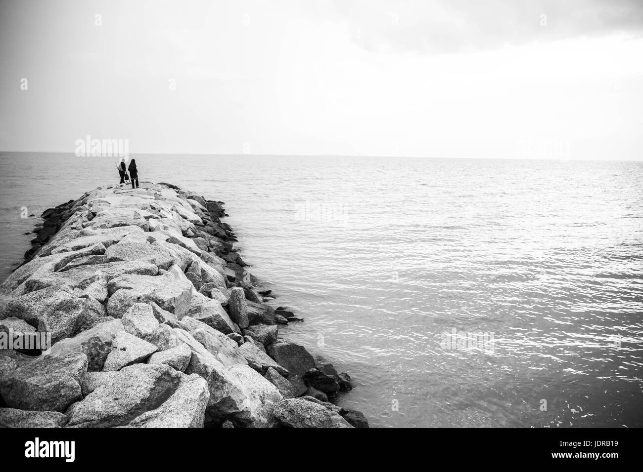 Stone breakwater in ocean Black and White Stock Photos & Images - Alamy