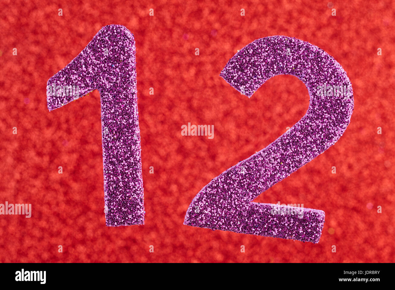Number twelve purple color over a red background. Anniversary ...