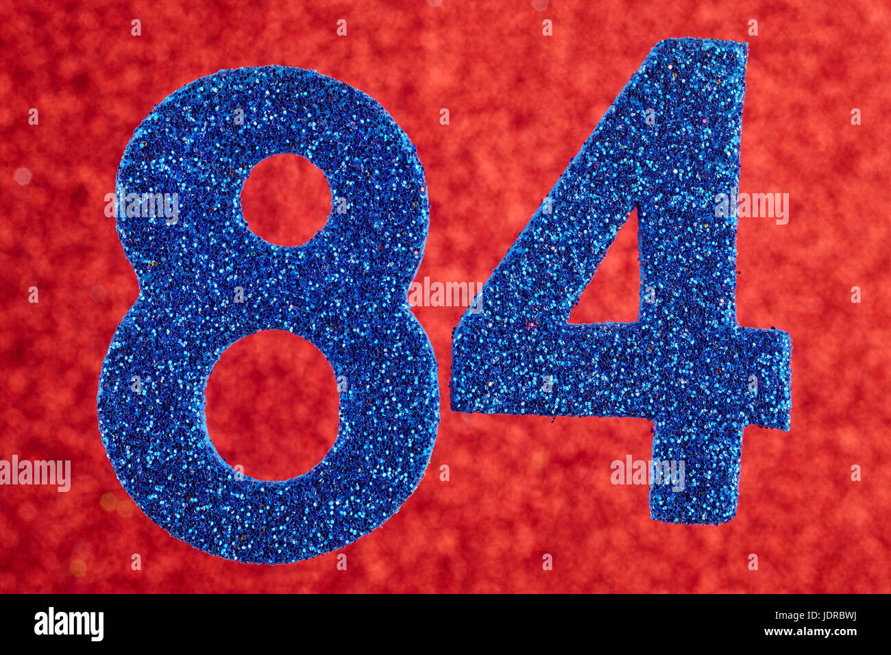 Number eighty-four blue color over a red background. Anniversary ...