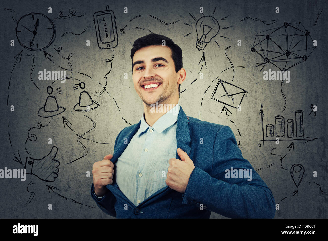 Young smiling businessman acting with courage like a super hero and ...