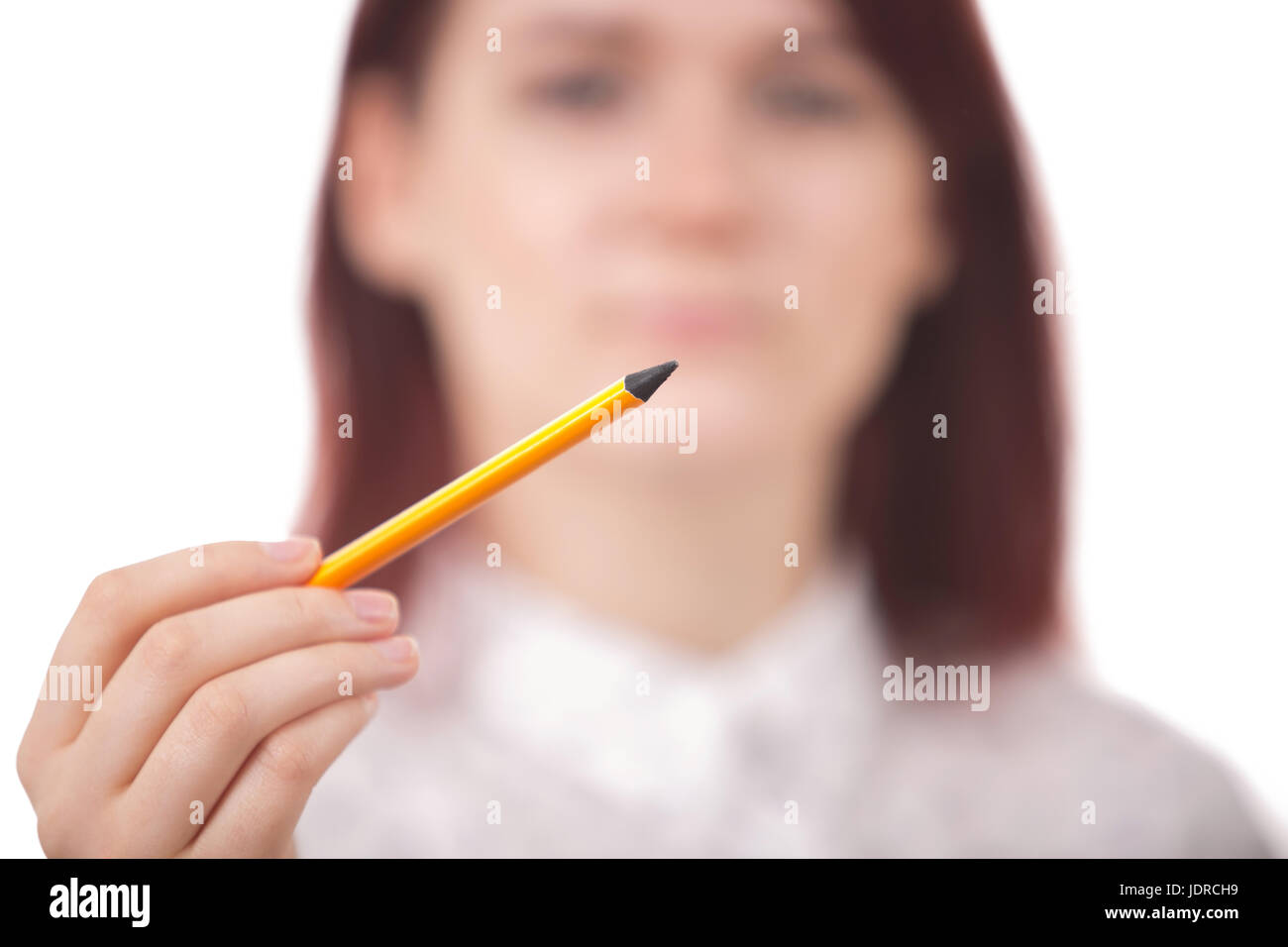 Smiling young student woman holding a pencil trying to develop her ...