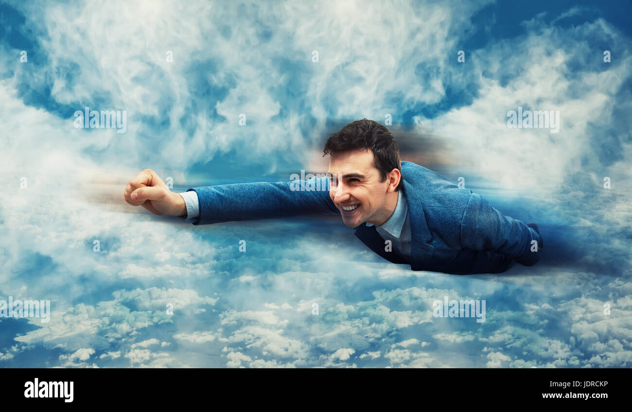 Happy, smiling businessman flying above the clouds like a superhero ...