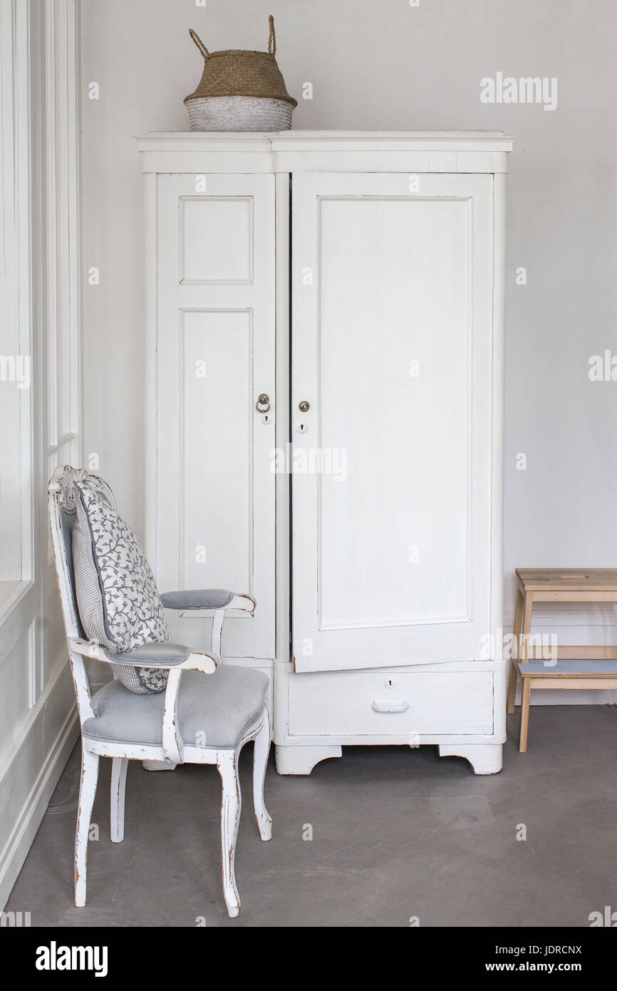 White wardrobe and chair Stock Photo - Alamy