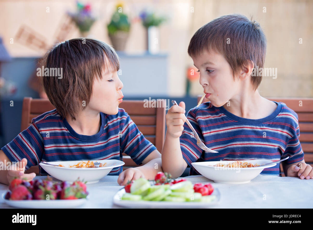 Cute children, preschool boys, eating spaghetti for lunch outdoors in ...