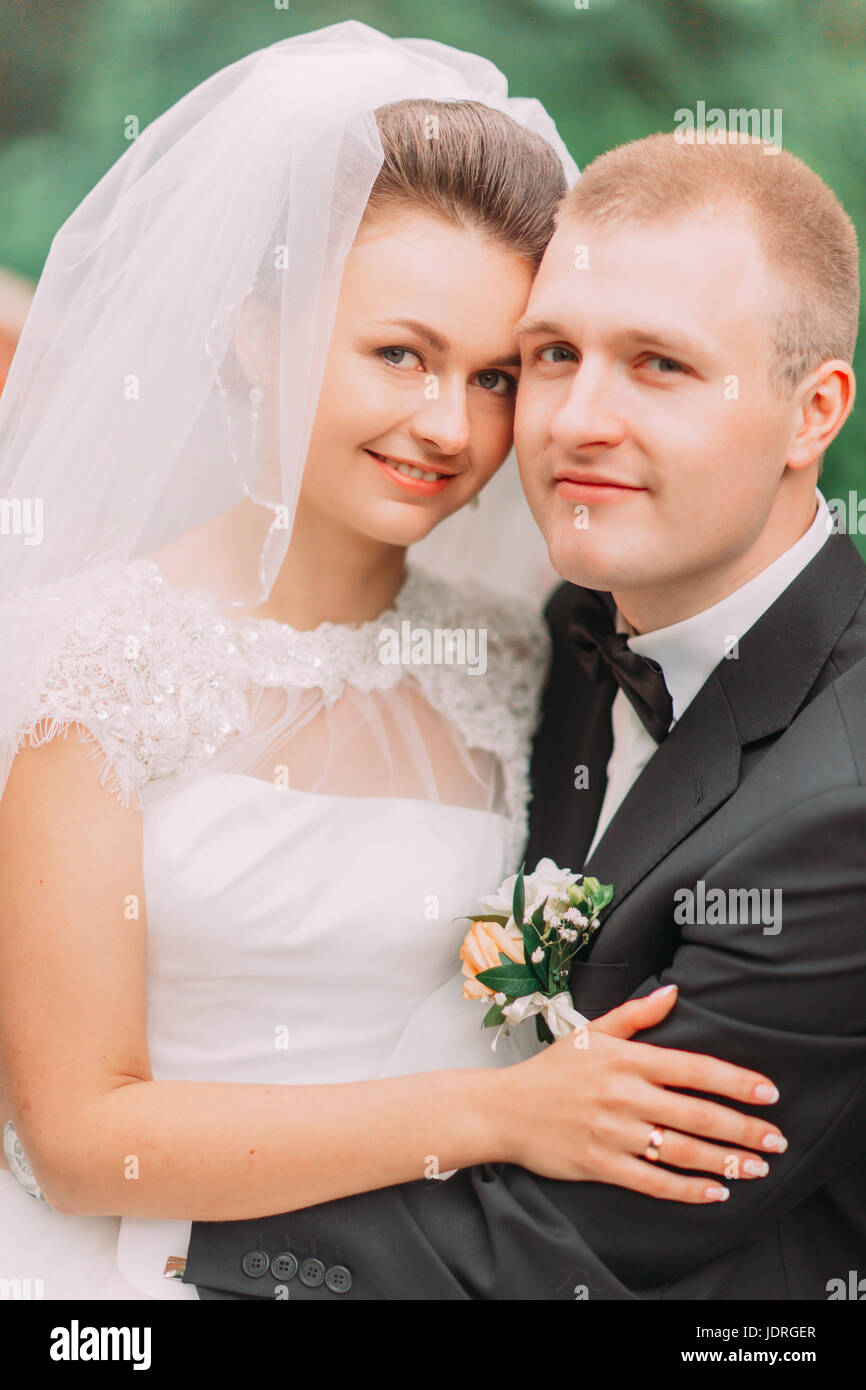 The portrait of cheerful newlyweds in the park Stock Photo - Alamy