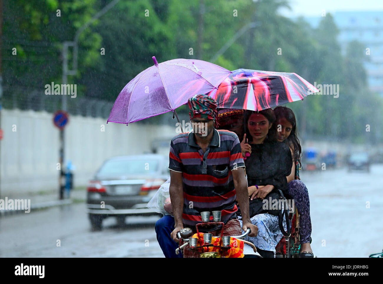 Commuters walk through the heavy rain in the capitals and several other ...