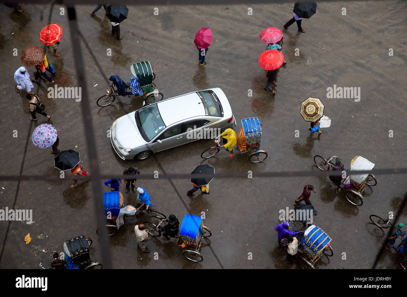 Commuters walk through the heavy rain in the capitals and several other ...