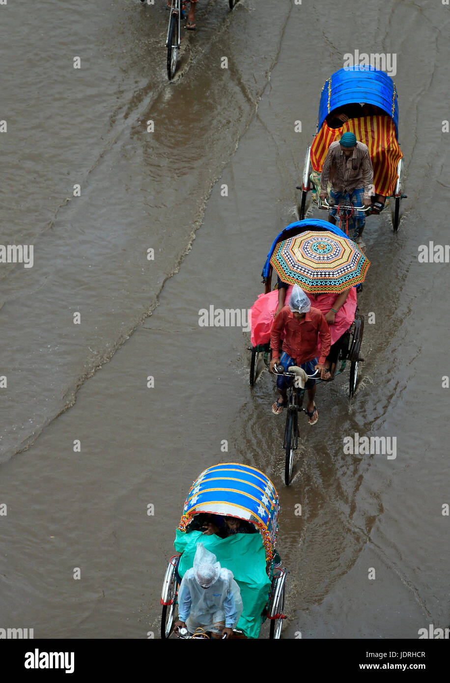 Commuters walk through the heavy rain in the capitals and several other ...