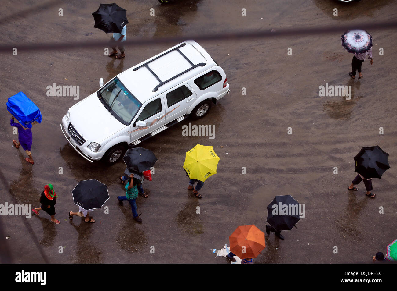 Commuters walk through the heavy rain in the capitals and several other ...